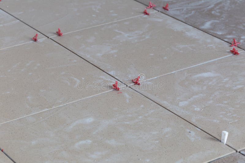 New Ceramic Stoneware Tiles on the Floor with Tile Crosses Stock Image ...