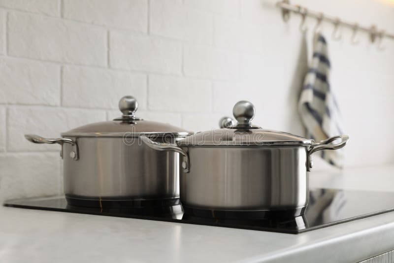 New Pots on Cooktop in Kitchen Stock Photo - Image of house, pots ...