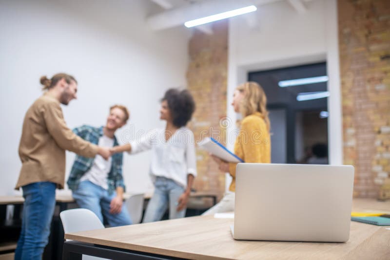 Group of Young Professionals Meeting a New Colleague and Looking ...