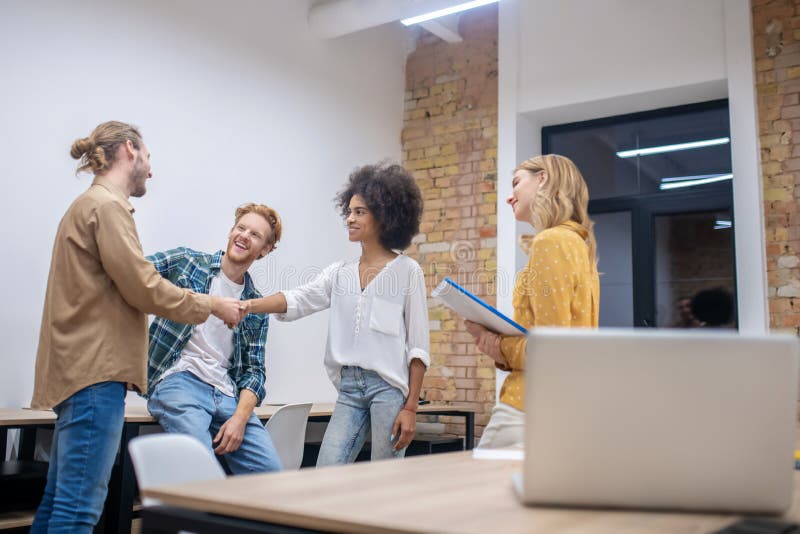 Group of Young Professionals Meeting a New Colleague and Looking ...