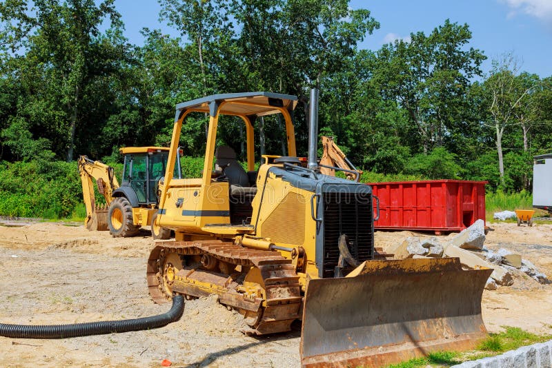 New Construction Tractor Excavators and Garbage Containers Stock Image ...