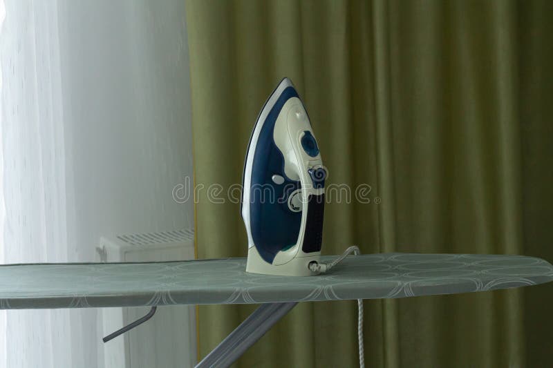 New Electric Steam Iron on Ironing Board Stock Image - Image of fabric ...