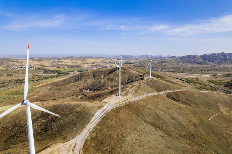 Windmills Stand Tall in a Large Body of Water, Their Blades Spinning ...