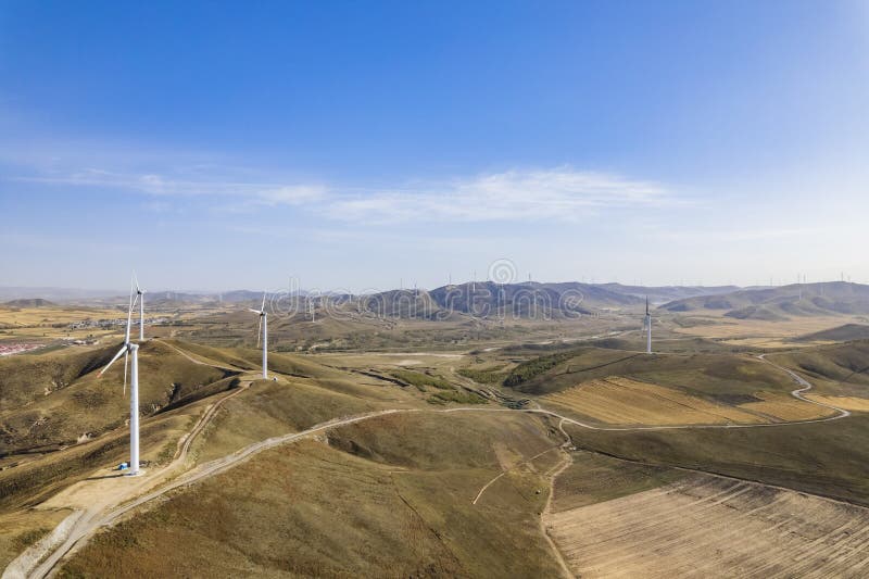 Windmills Stand Tall in a Large Body of Water, Their Blades Spinning ...