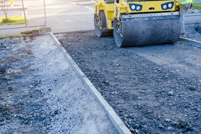 A New Footpath is Under Construction As Builders Bring Stone, Levelling ...