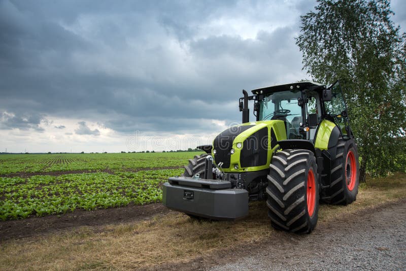 A New Green Tractor Stands Near the Field, Beautiful Sky Stock Image ...