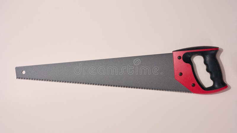 New Hand Saw with a Rubber Red Handle on a Beige Background Stock Photo ...