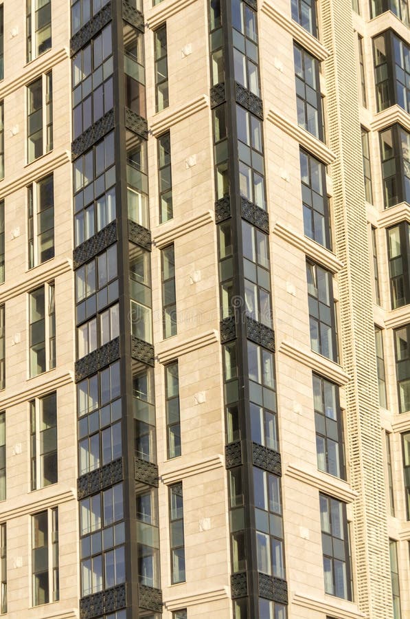 New High-rise Building Decorated with Stone Slabs with Large Windows ...