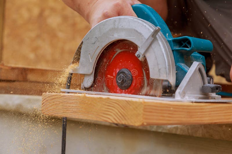 Building Contractor Worker Using Hand Held Worm Drive Circular Saw To ...