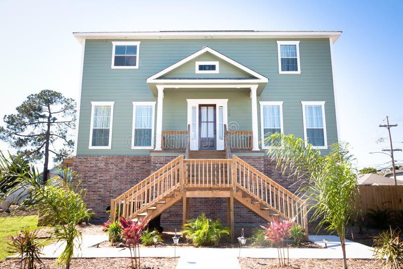 New Home: Modern Elevated Home Stock Photo - Image of brick, fence ...