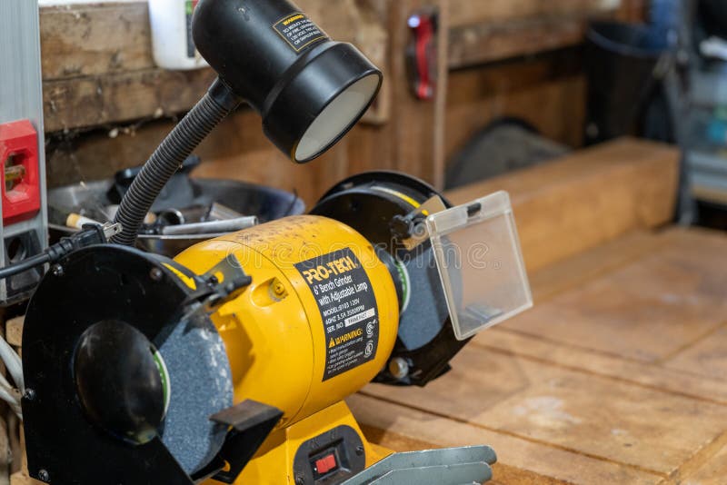 A Pro-Tech Bench Grinder on a Workbench in a Garage Editorial Stock ...