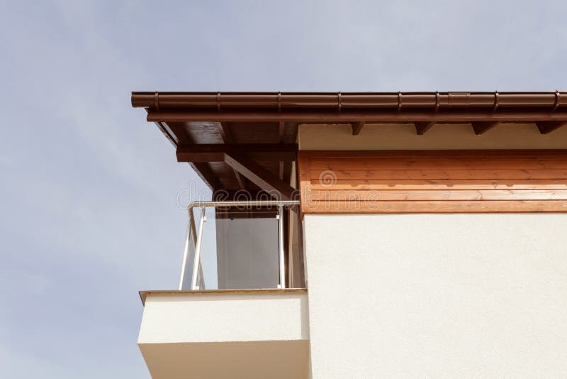 New House with Brown Rain Gutter, White Wall and Balcony. Stock Photo ...