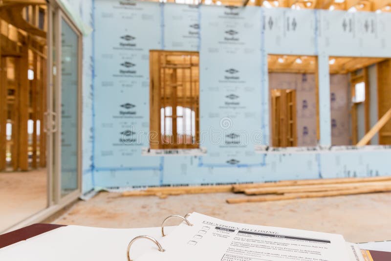 A New House Under Construction and New Home Closing Documents Folder ...