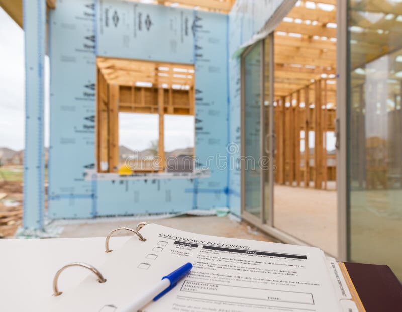 A New House Under Construction and New Home Closing Documents Folder ...
