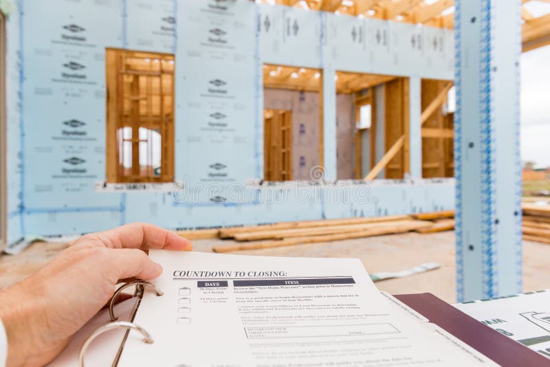 A New House Under Construction and New Home Closing Documents Folder ...