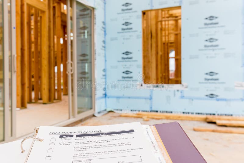 A New House Under Construction and New Home Closing Documents Folder ...