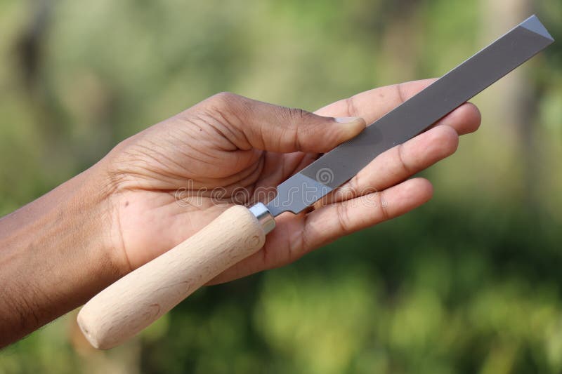 New Iron File Tool with Wooden Handle Held in the Hand Isolated on ...
