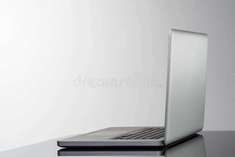 New Laptop Side View with a Popular Design on Table Stock Photo - Image ...