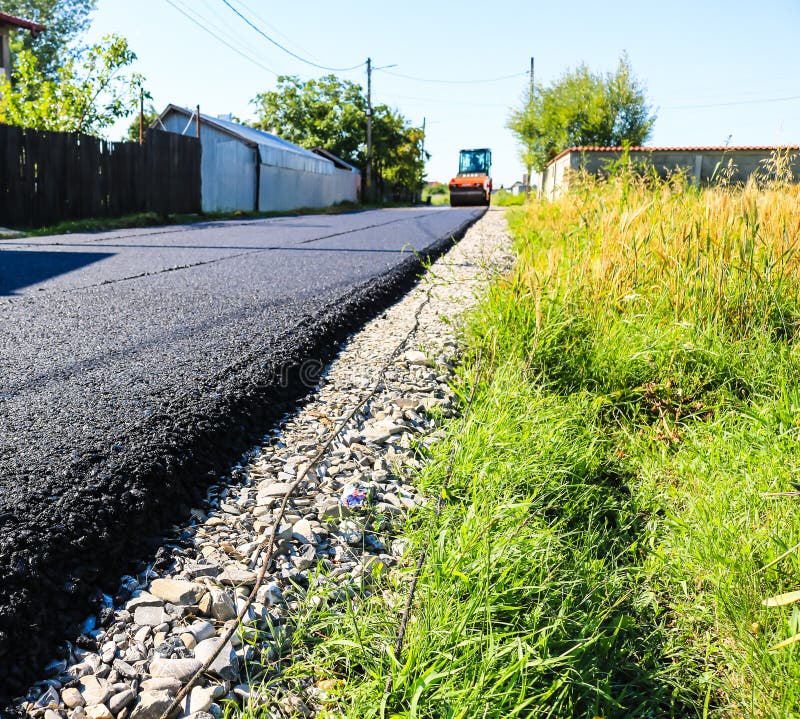 New Layer of Asphalt Road Under Construction with Support from the ...