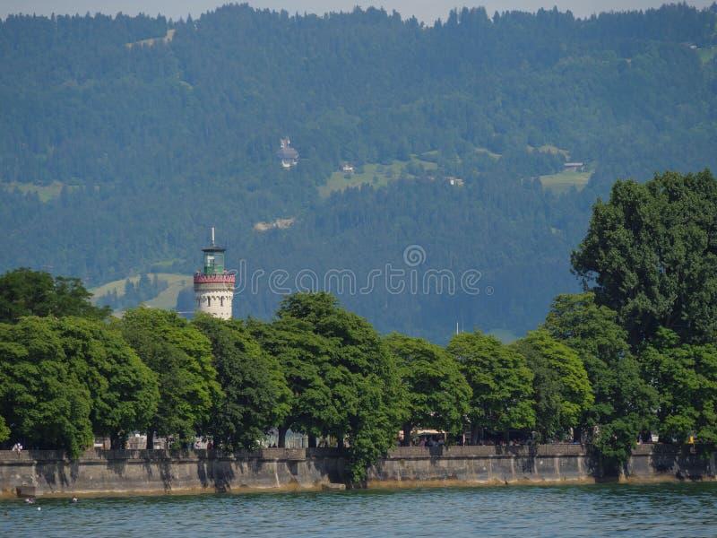 New Lindauer Lighthouse Surrounded by Lush Trees with a Dense Forest in ...