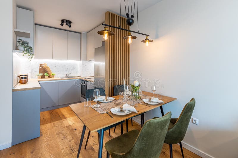 New Modern Kitchen with Table Served for Dinner. New Home. Interior ...