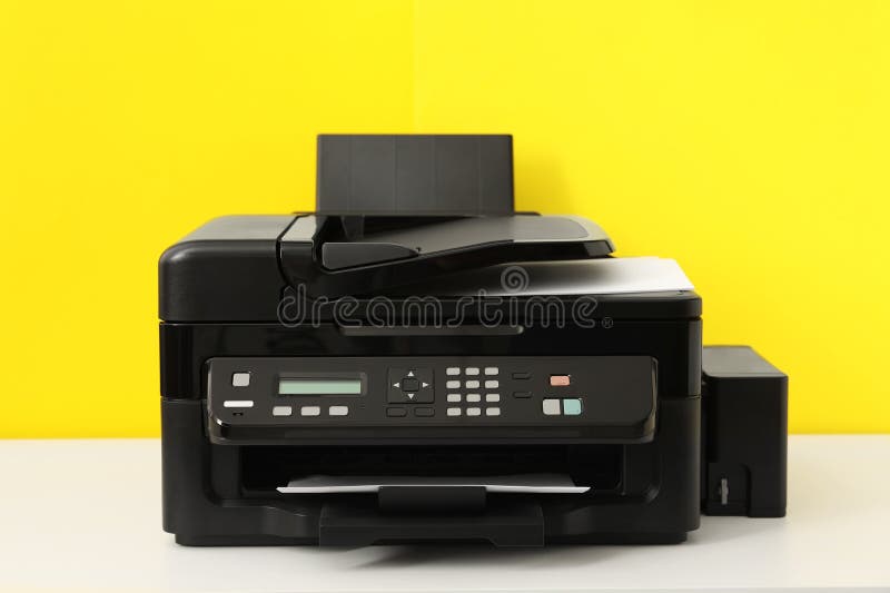 New Modern Printer on White Table Against Yellow Background Stock Image ...