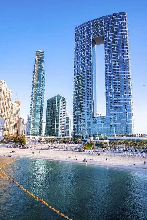 Beautiful Modern Skyscrapers with Beach Against Clear Blue Sky Stock ... Beautiful Modern Skyscrapers with Beach Against Clear Blue Sky Stock ...