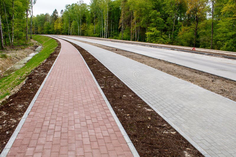 New Modern Tile Sidewalk Near a Road Under Construction Stock Photo ...