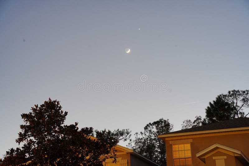 New Moon and Venus Shining Above a House and Tree Stock Photo - Image ...