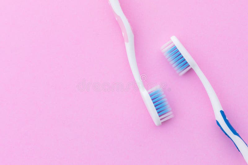 New Pink and Blue Toothbrush on Pink Background with Copy Space for ...