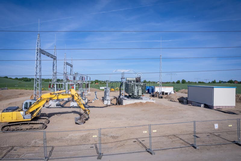 A New Power Substation is Built on a Field Stock Image - Image of pylon ...