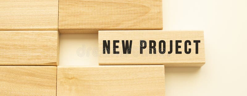 NEW PROJECT Text on a Strip of Wood Lying on a White Table Stock Photo ...