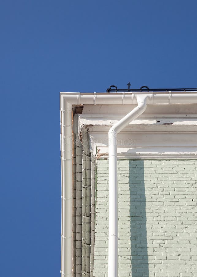 New Rain Gutter on a Brick Wall Against Blue Sky. Stock Photo - Image ...