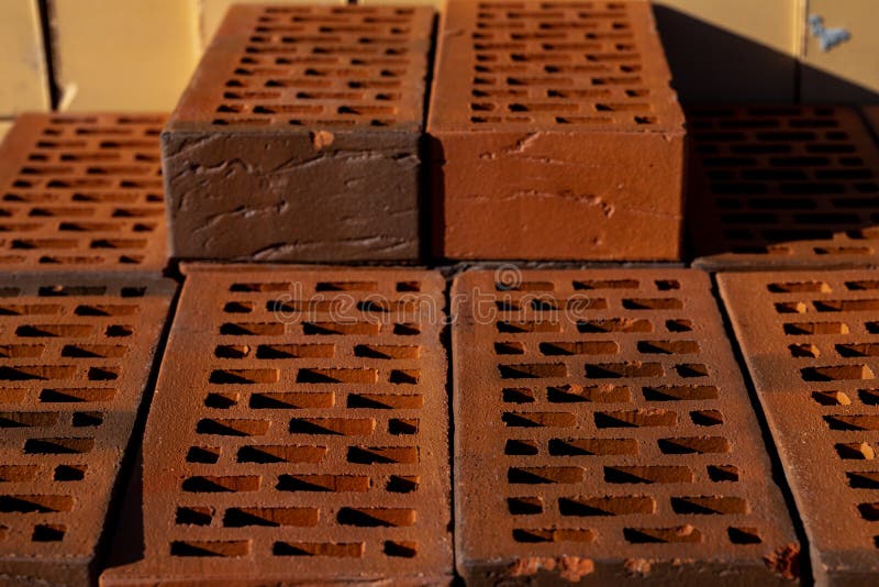 New Red Hollow Bricks at a Construction Site at Sunset. Rows of Trim ...