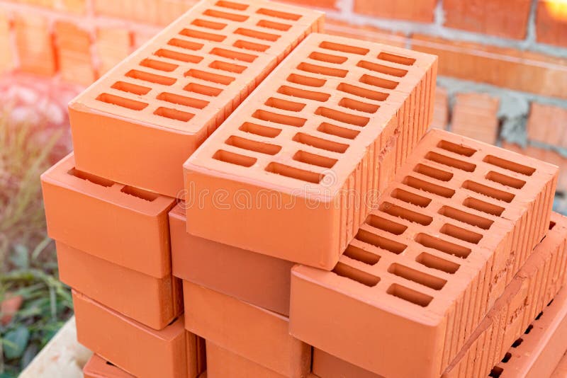New Red Hollow Bricks at a Construction Site at Sunset. Rows of Trim ...