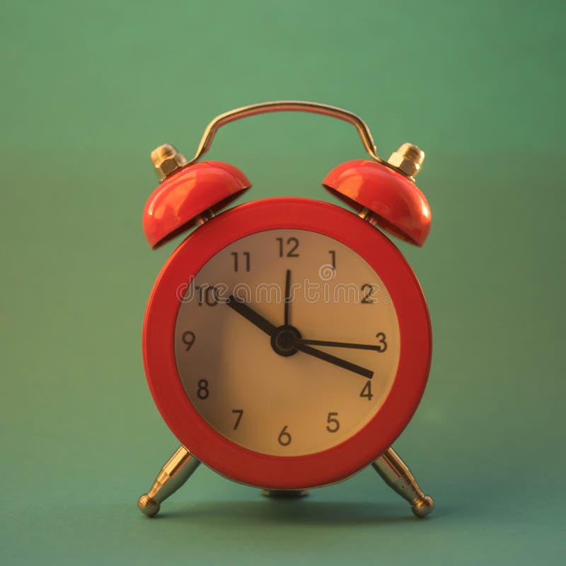 New Red Round Clock on Green Table, Side View Stock Photo - Image of ...