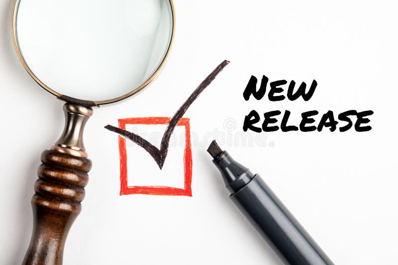 New Release. Magnifying Glass and Black Marker on a White Background ...