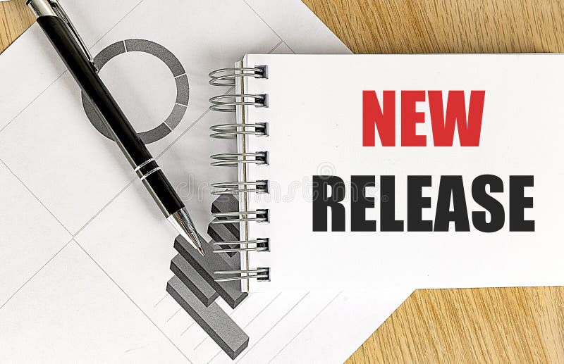 NEW RELEASE Text on Notebook with Chart on Wooden Background Stock ...