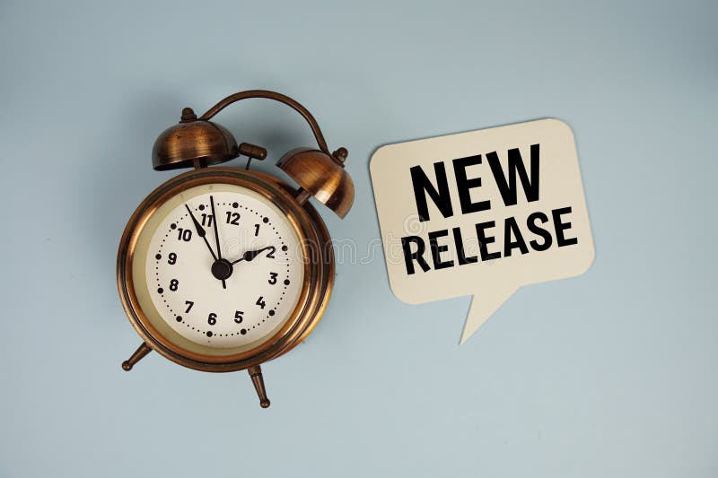 New Release Text on Speech Bluble with Alarm Clock Top View on Blue ...