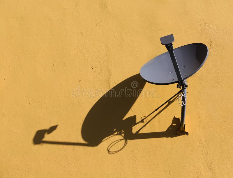 New Satellite Dish Reflects Its Shadow on Yellow Wall Stock Image ...