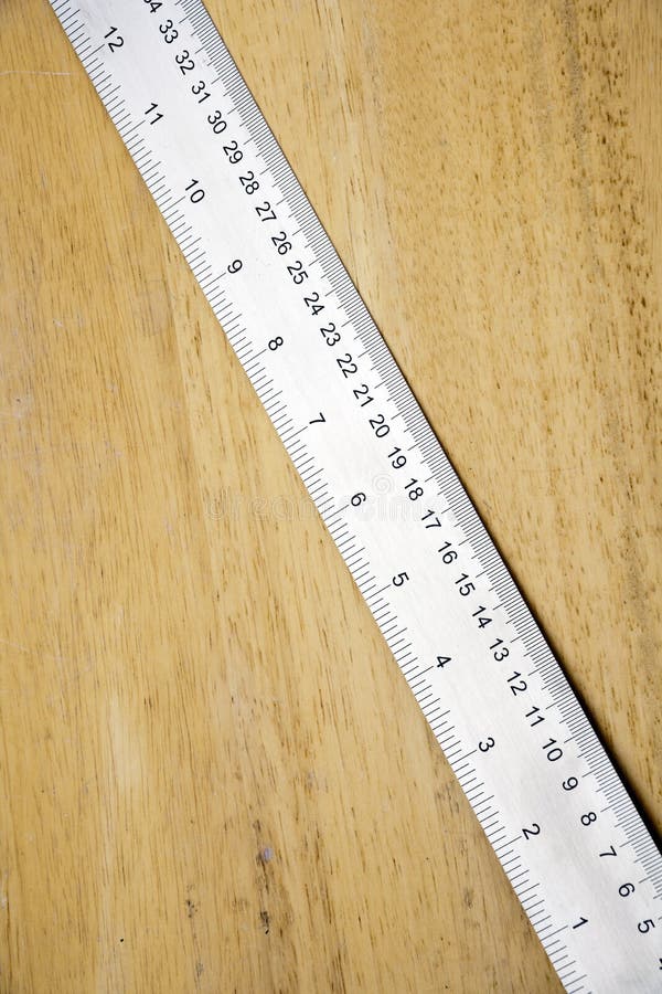 A new steel rule on wood stock image. Image of space - 159014197