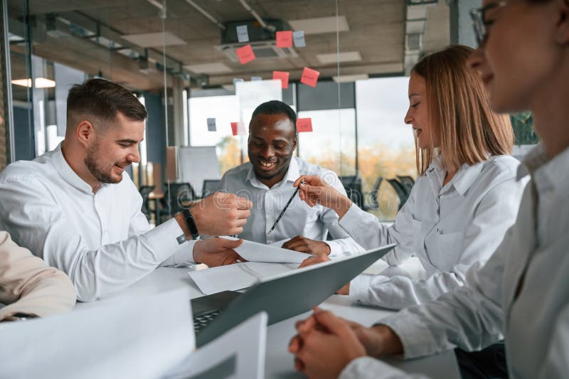 New Technology for the Project. Talking, Sitting by Table Stock Photo ...