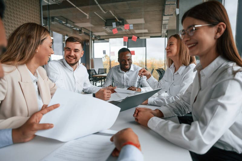 New Technology for the Project. Talking, Sitting by Table Stock Image ...