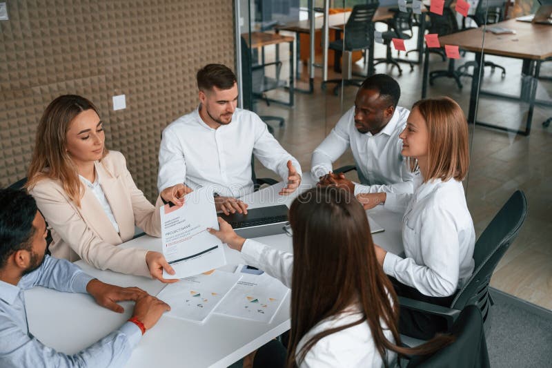 New Technology for the Project. Talking, Sitting by Table Stock Image ...