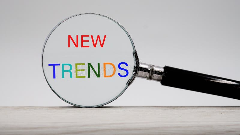 NEW TRENDS Text Written on Magnifying Glass Stock Image - Image of ...
