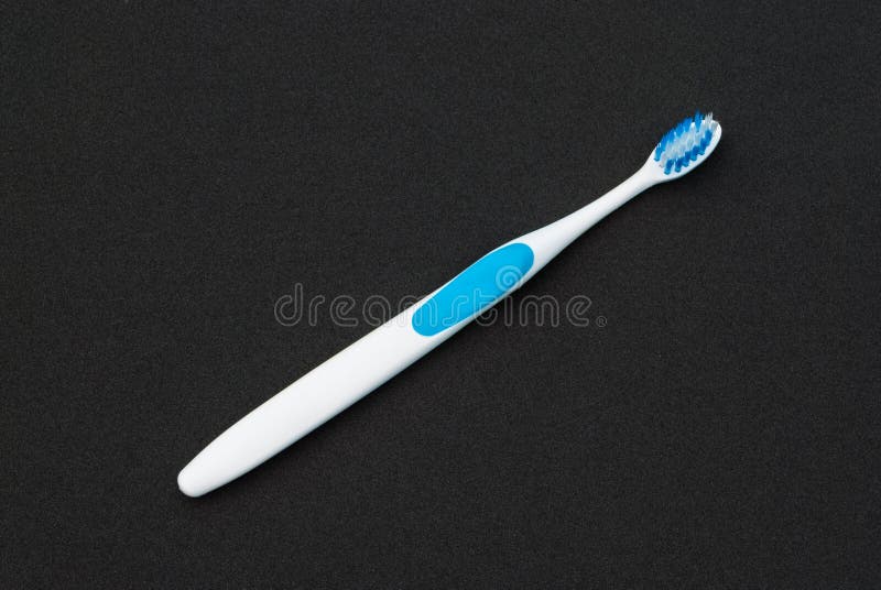 New White and Blue Toothbrush in Good Condition on Black Foam Sheet ...