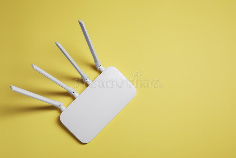 New White Wi-Fi Router on Yellow Background, Top View. Space for Text ...