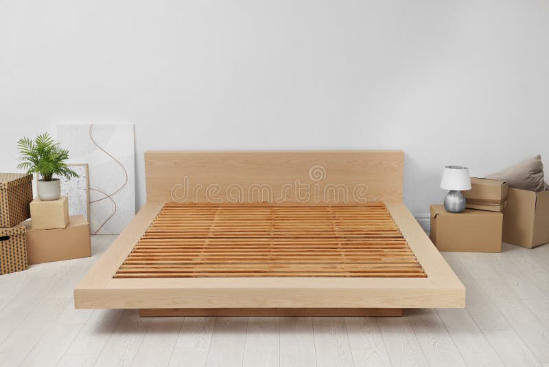 New Wooden Bed Frame, Moving Boxes and Decor Elements Indoors Stock ...