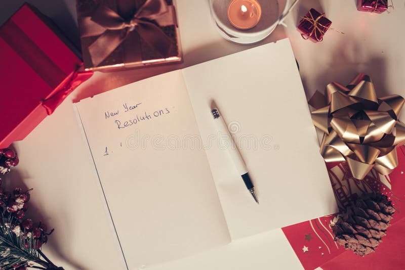 New Year Resolutions Written on Notebook with New Years Decorations ...