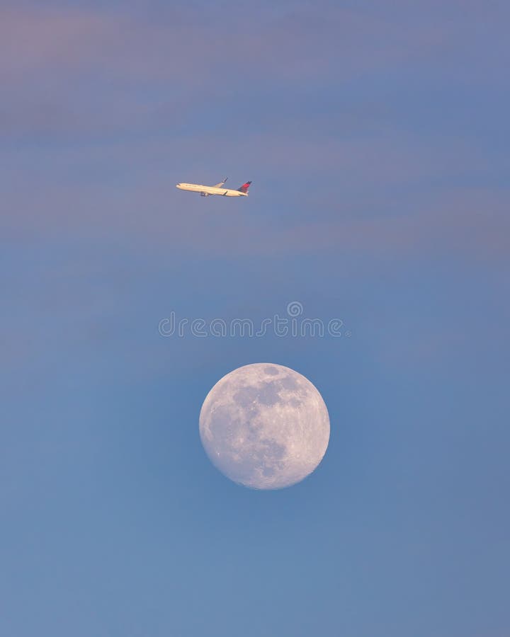 A Delta Plane in Flight, Closely Passing an almost Full Moon Editorial ...